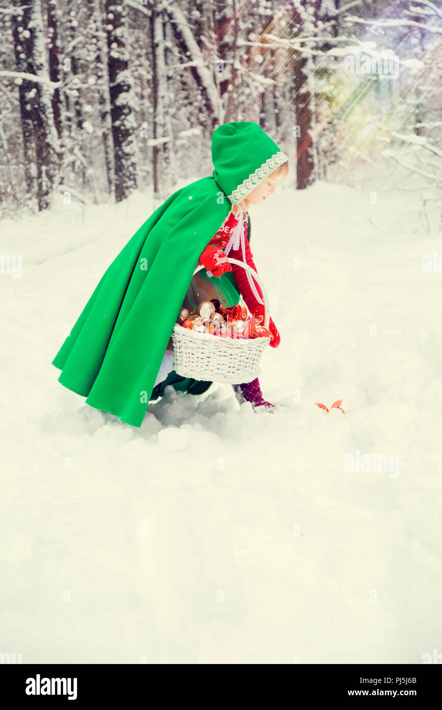 a red-haired girl with long hair in a lush skirt and a green cloak with ...