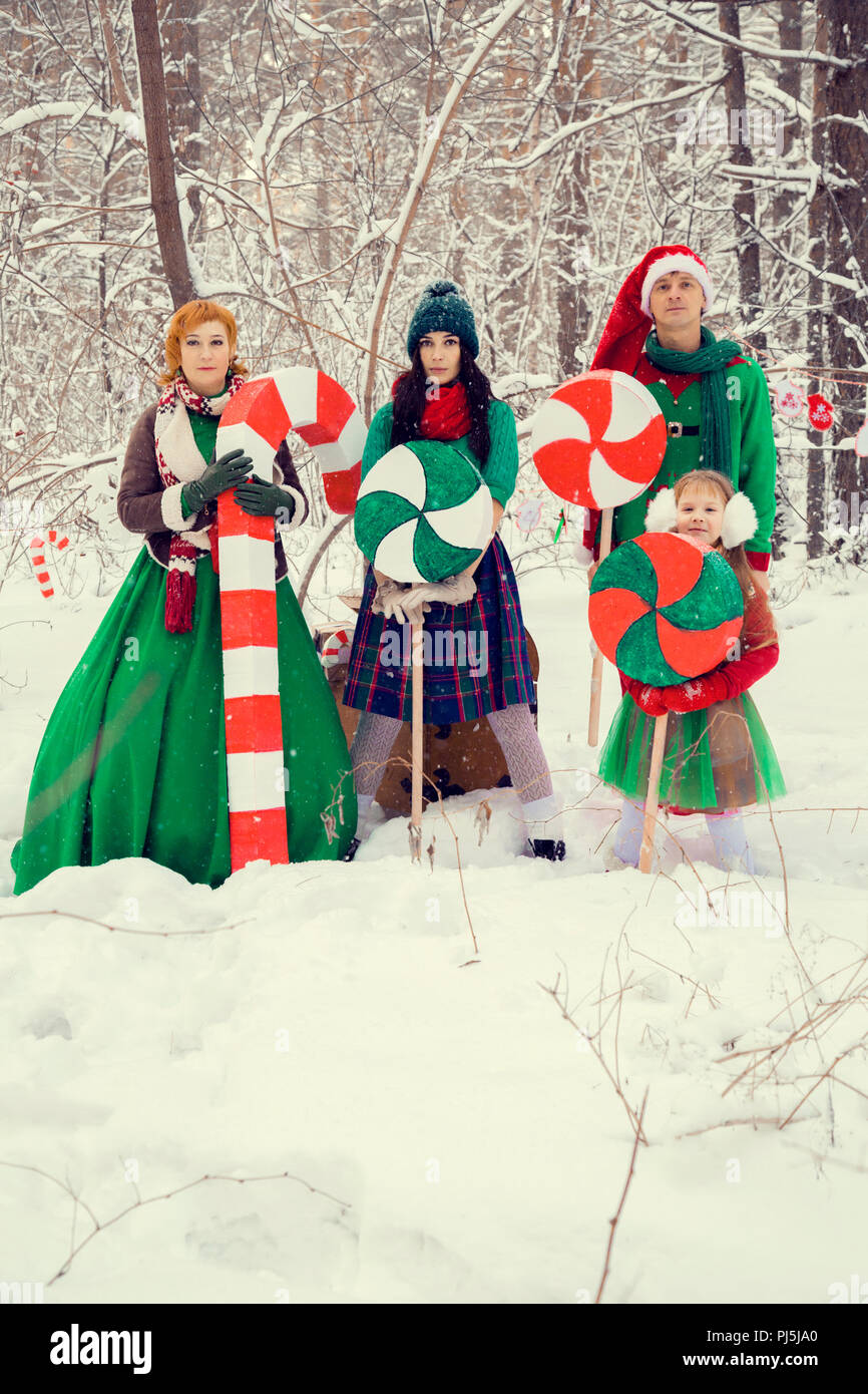 family in traditional Christmas flower costumes, red - green , Santa's ...