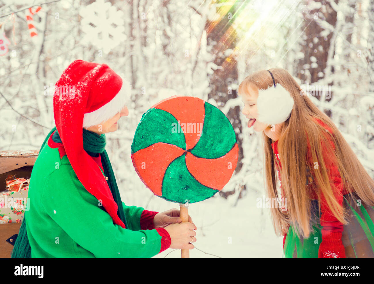 father and little daughter walk in costumes of flowers traditional for ...
