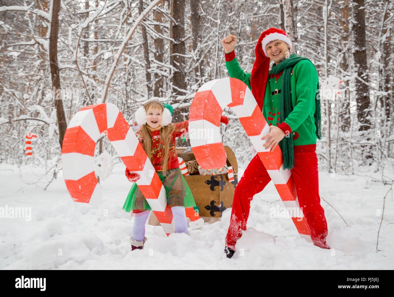 father and little daughter walk in costumes of flowers traditional for ...