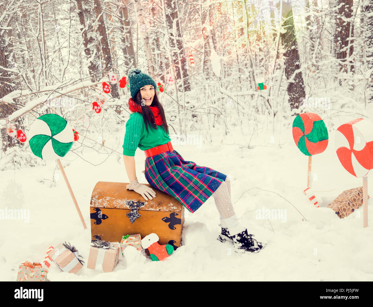 brunette girl in a green hat and in a costume of flowers traditional to ...