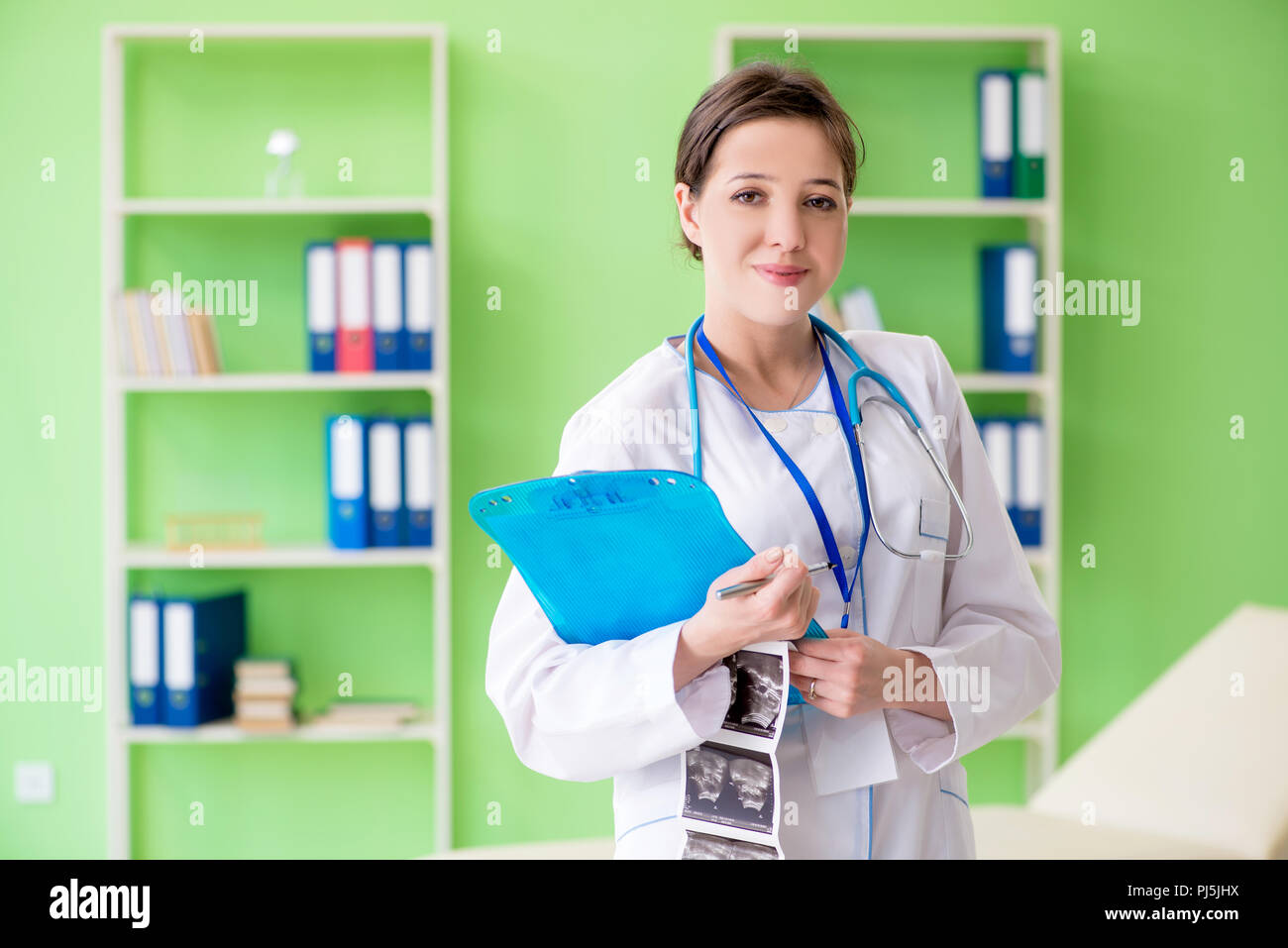 Female doctor gynecologyst writing medical record in the clinic Stock ...