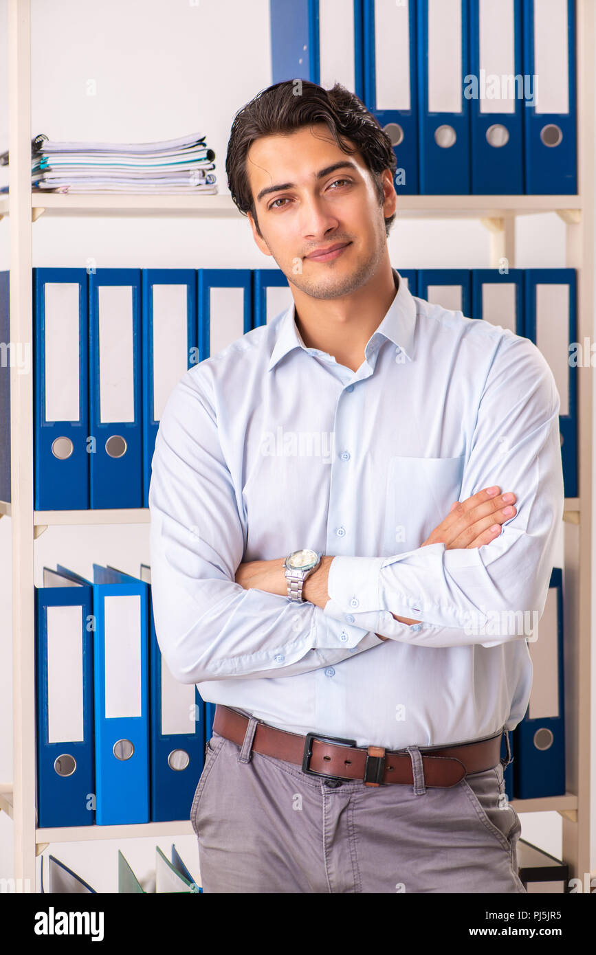 Young male employee working in the office Stock Photo - Alamy