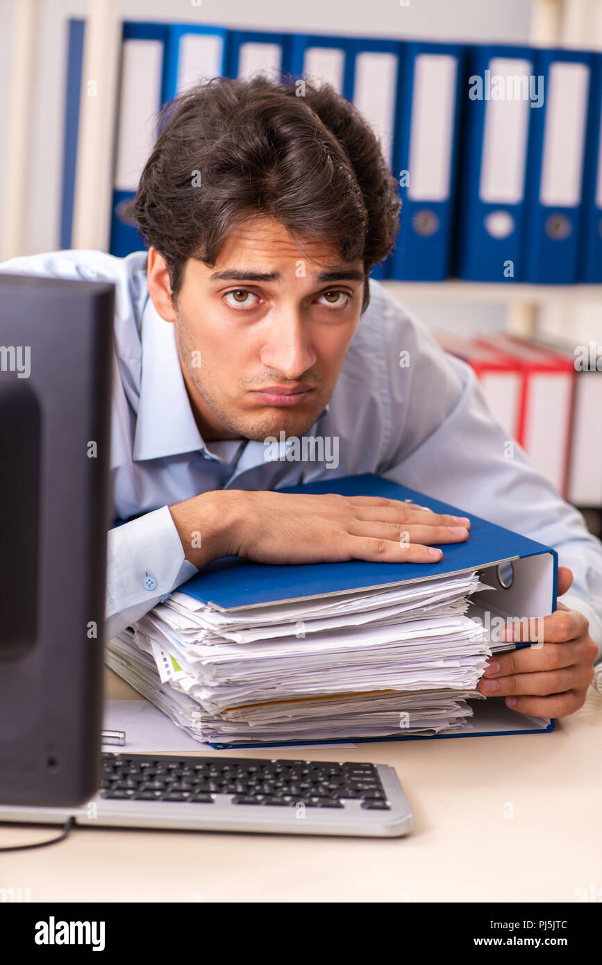 Overloaded busy employee with too much work and paperwork Stock Photo ...