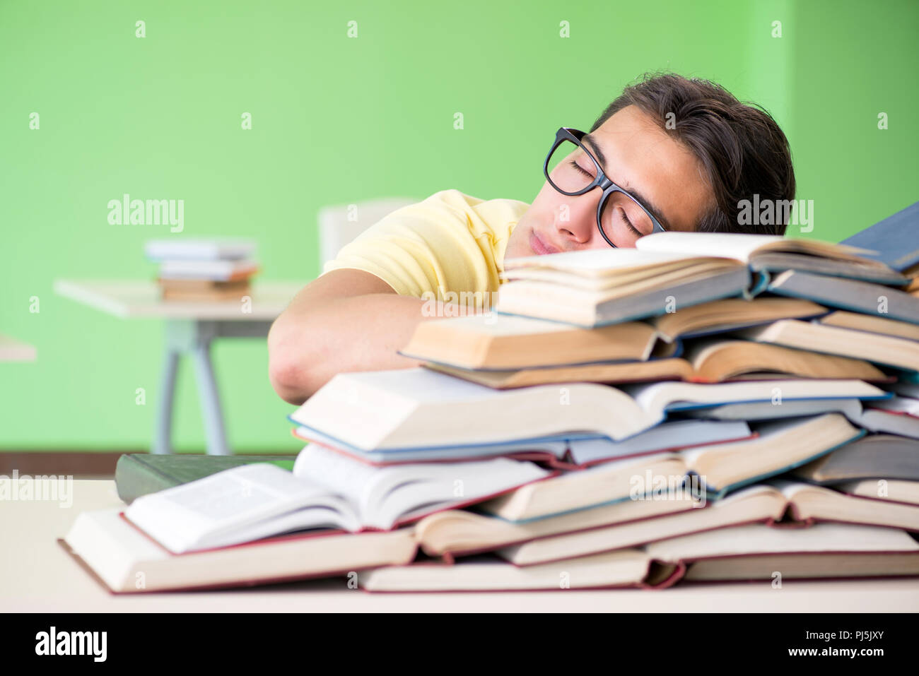 Student with too many books to read before exam Stock Photo - Alamy