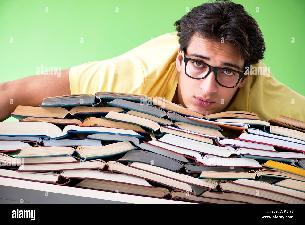 Student with too many books to read before exam Stock Photo - Alamy