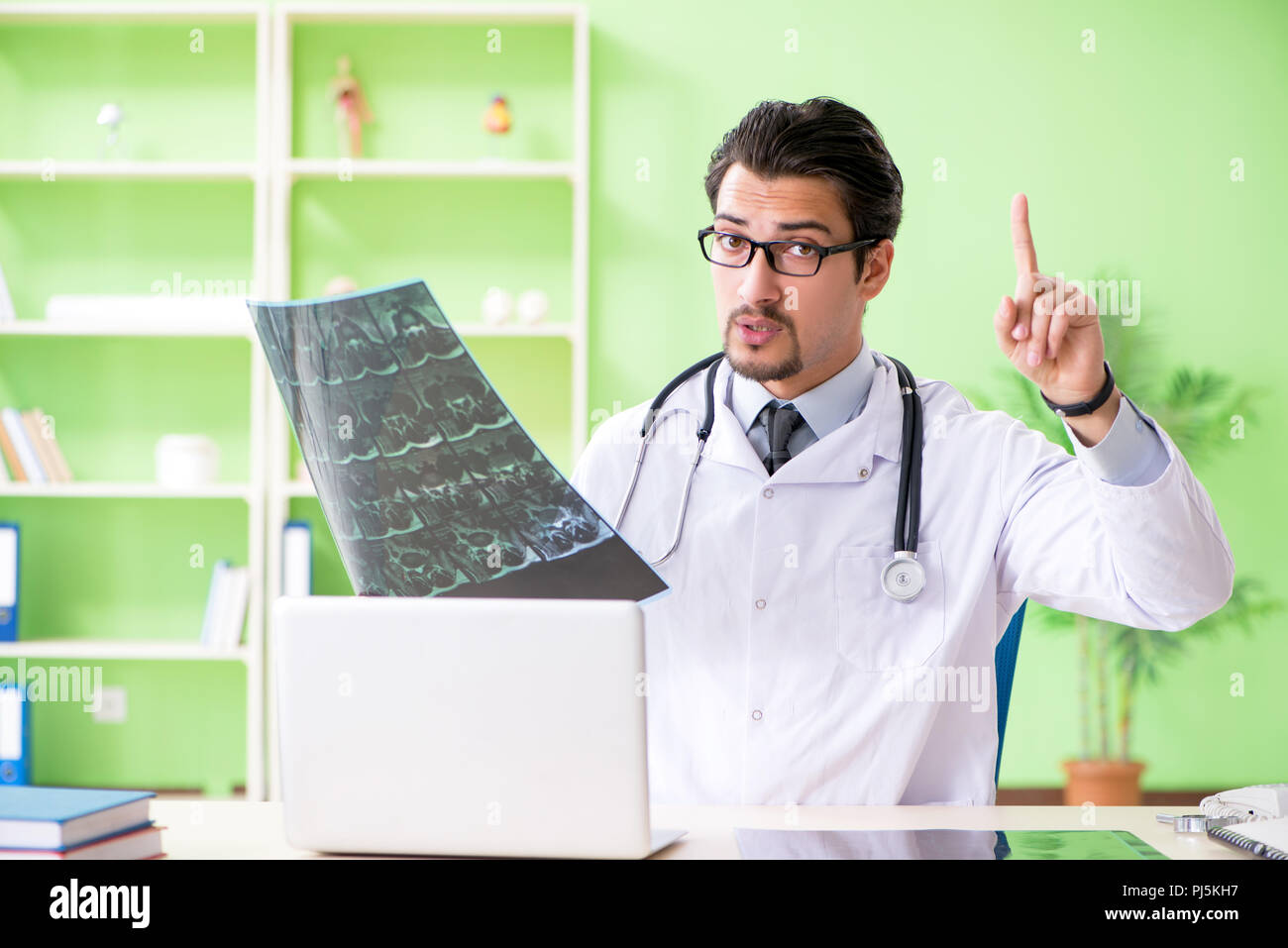 Doctor radiologist looking at x-ray scan in hospital Stock Photo - Alamy