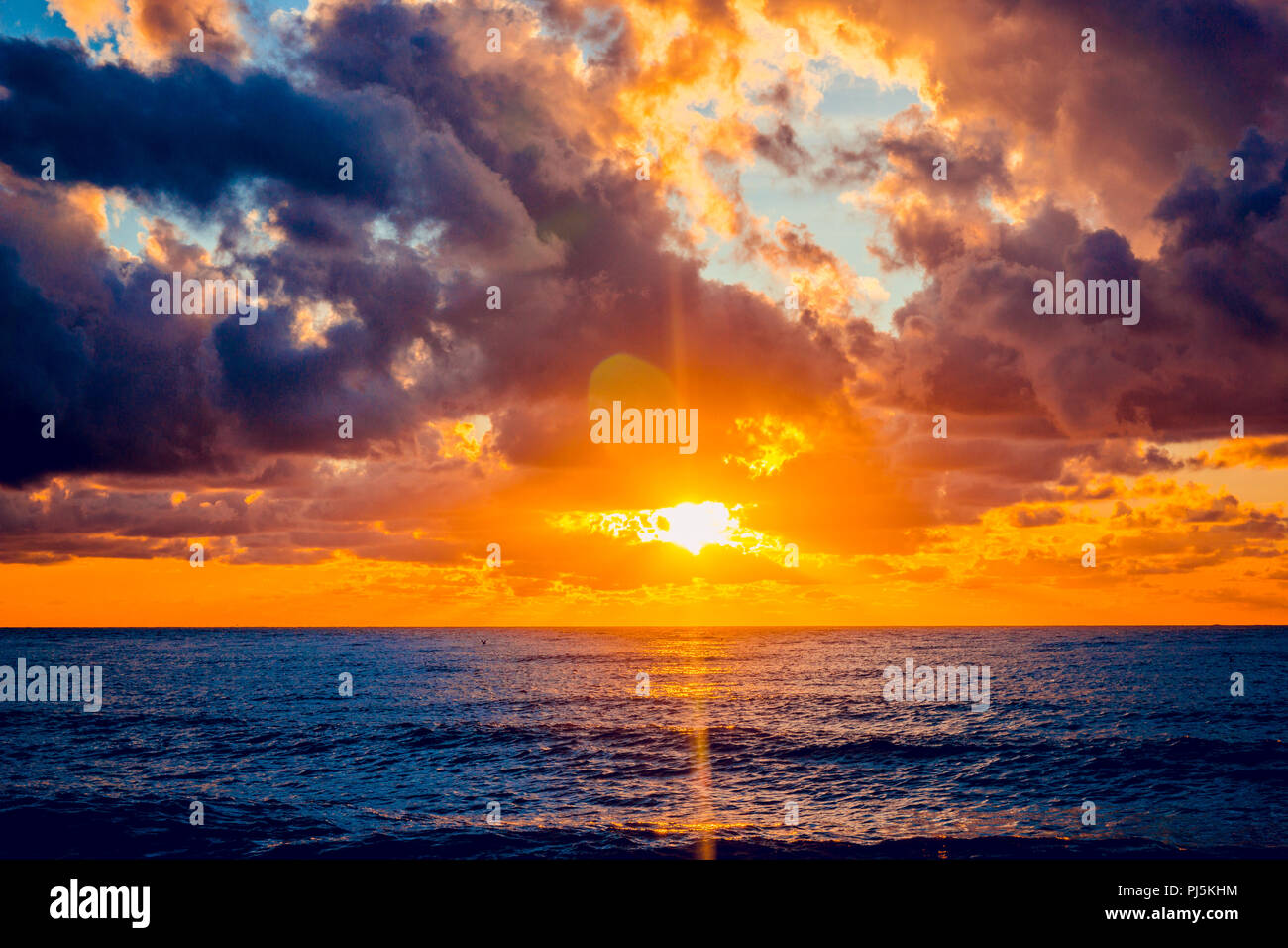 Colorful sunset over ocean Stock Photo - Alamy