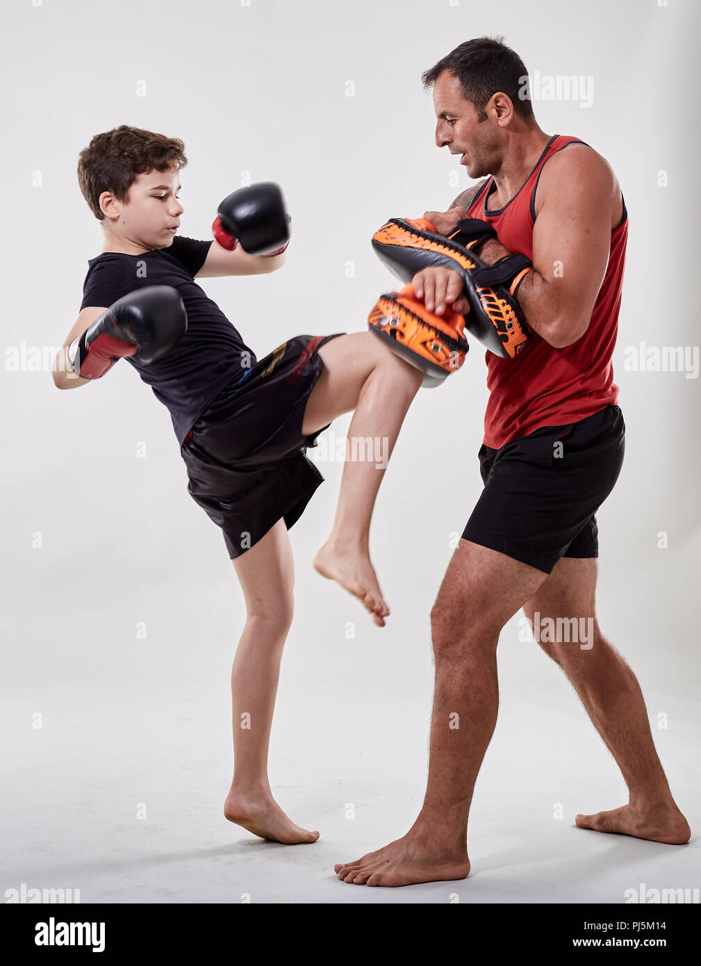 Boy boxing training punch mitts hi-res stock photography and images - Alamy