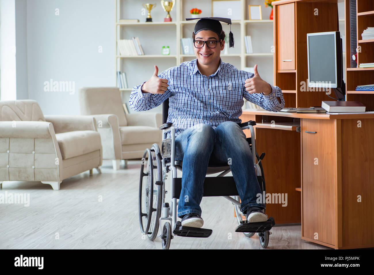 Disabled student studying at home on wheelchair Stock Photo - Alamy