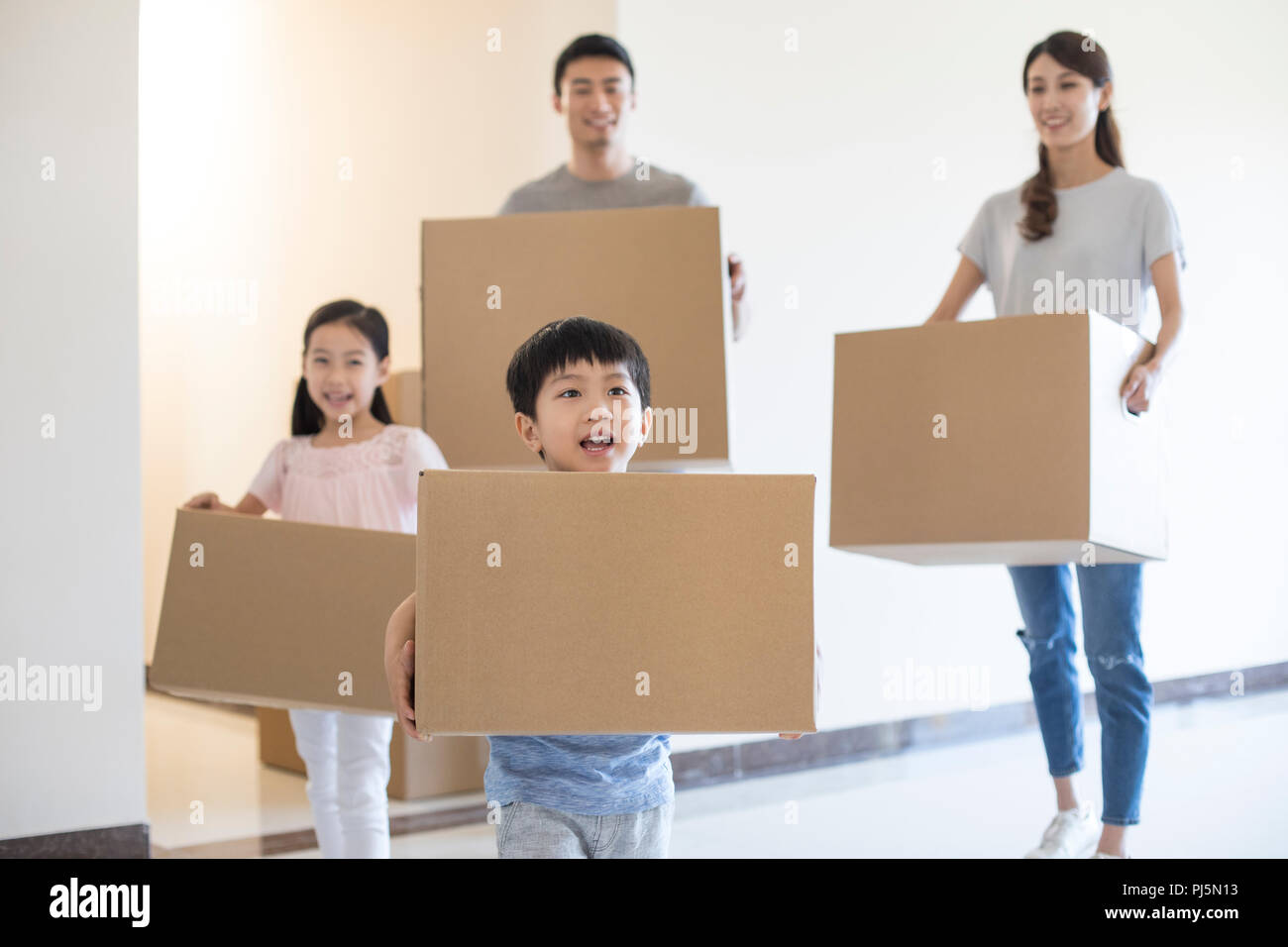 Happy young family moving home Stock Photo - Alamy