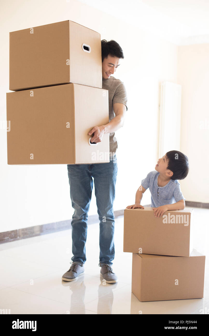 Happy young father and son moving home Stock Photo - Alamy
