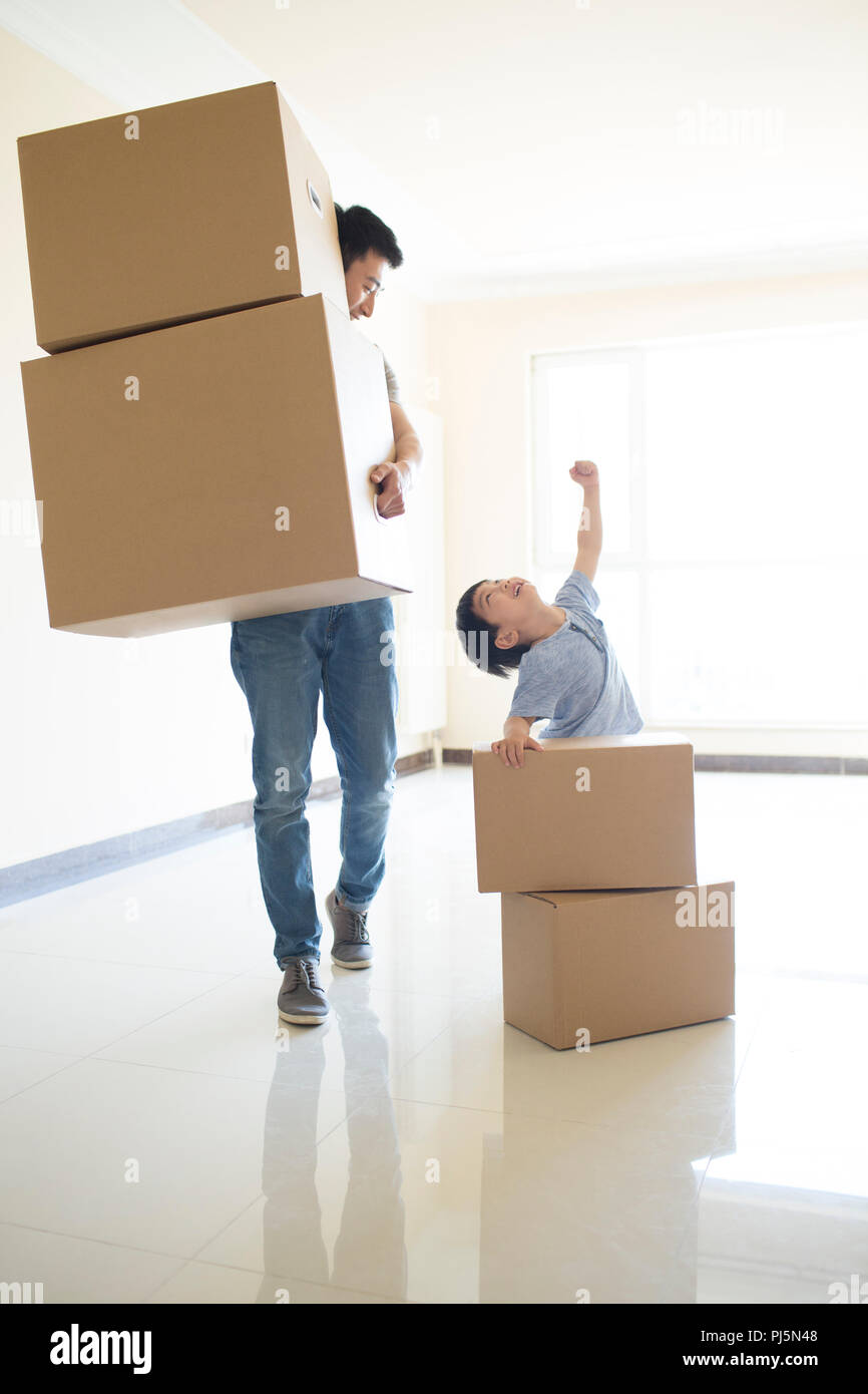 Happy young father and son moving home Stock Photo - Alamy