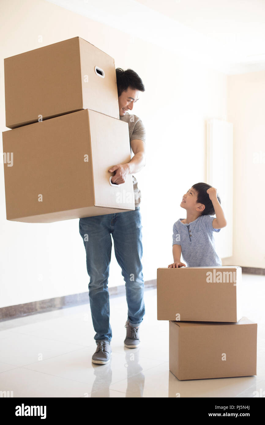 Happy young father and son moving home Stock Photo - Alamy