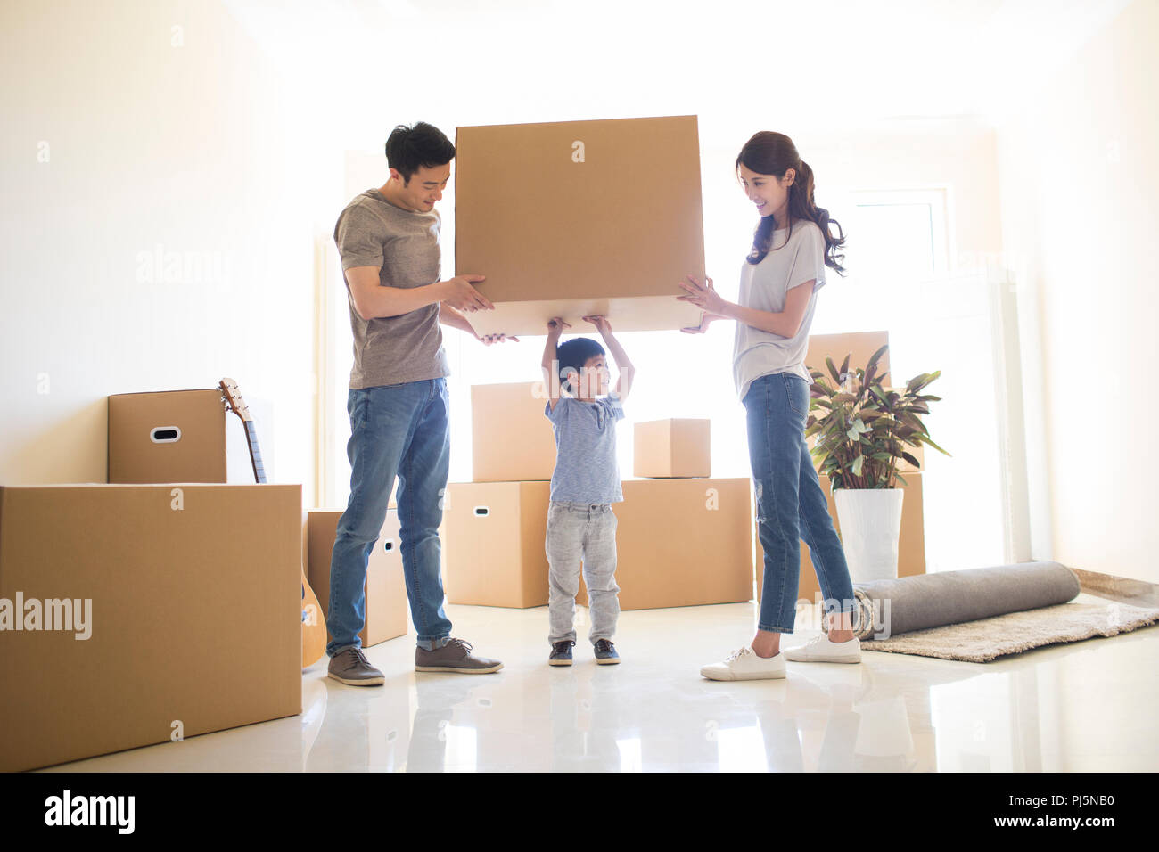 Happy young family moving to a new house Stock Photo - Alamy