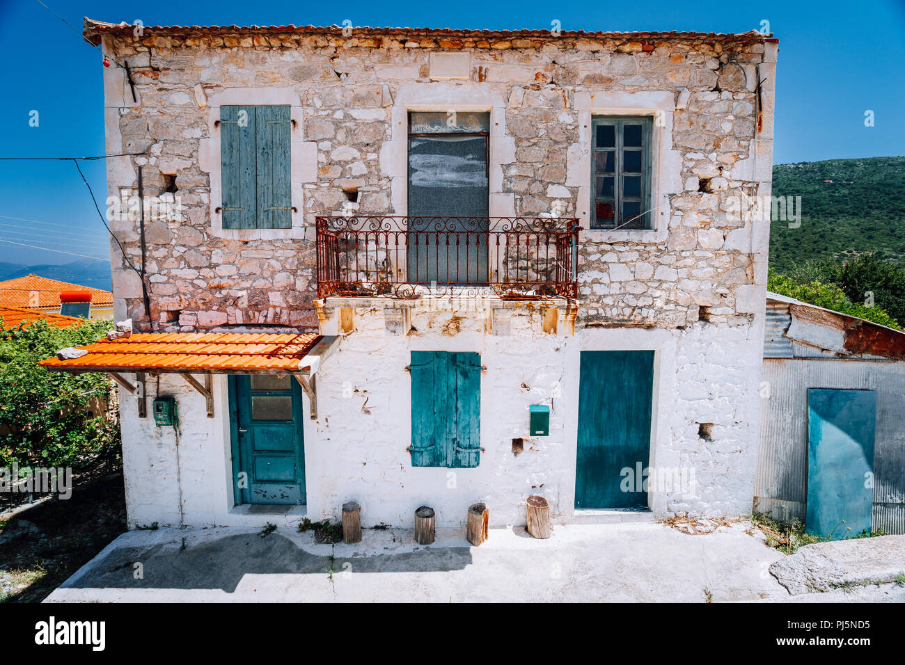Abandoned Mediterranean house on the top of the green hill in the ...