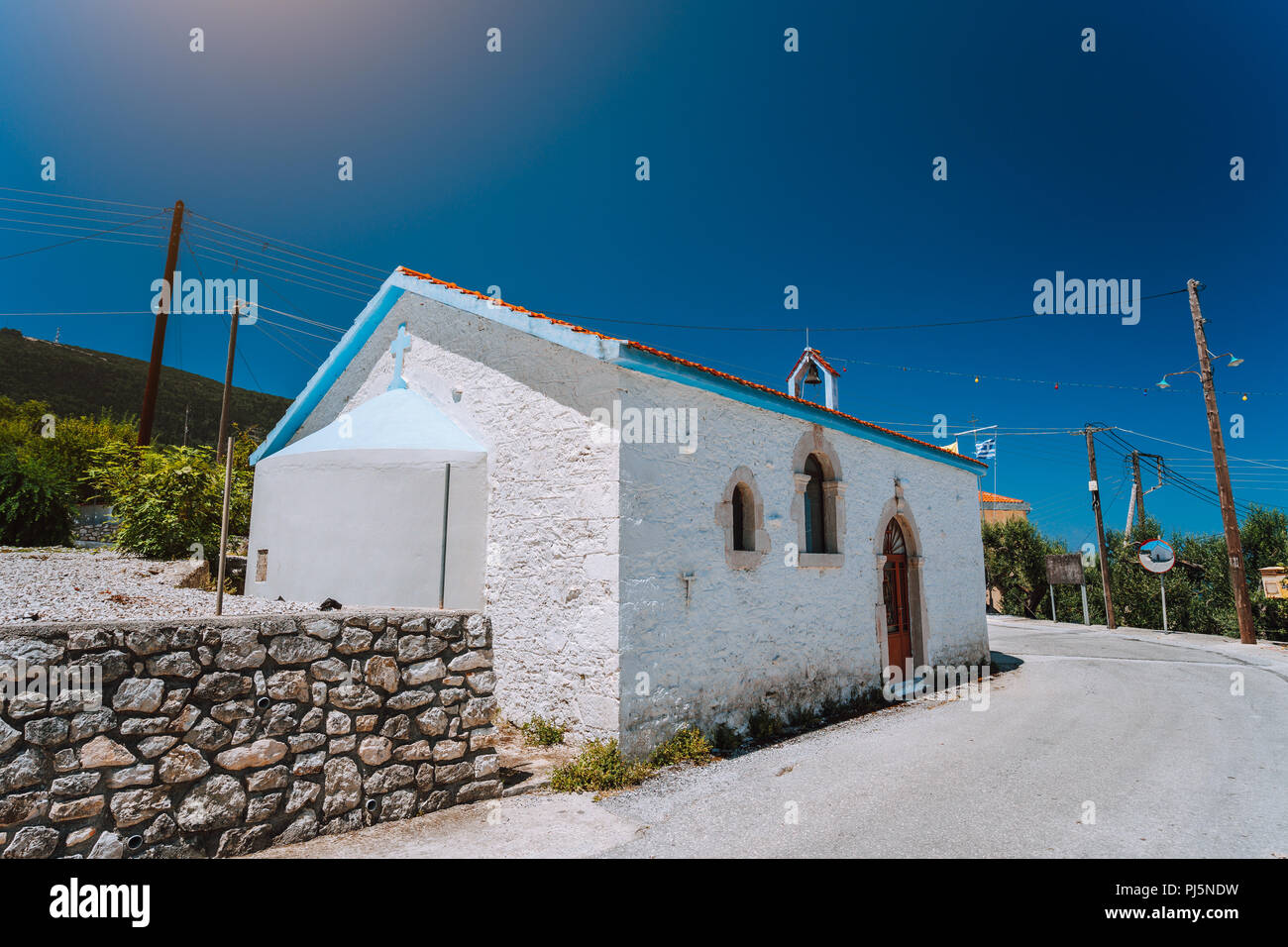 A small white chalk Greek Orthodox chapel in countryside on the narrow ...