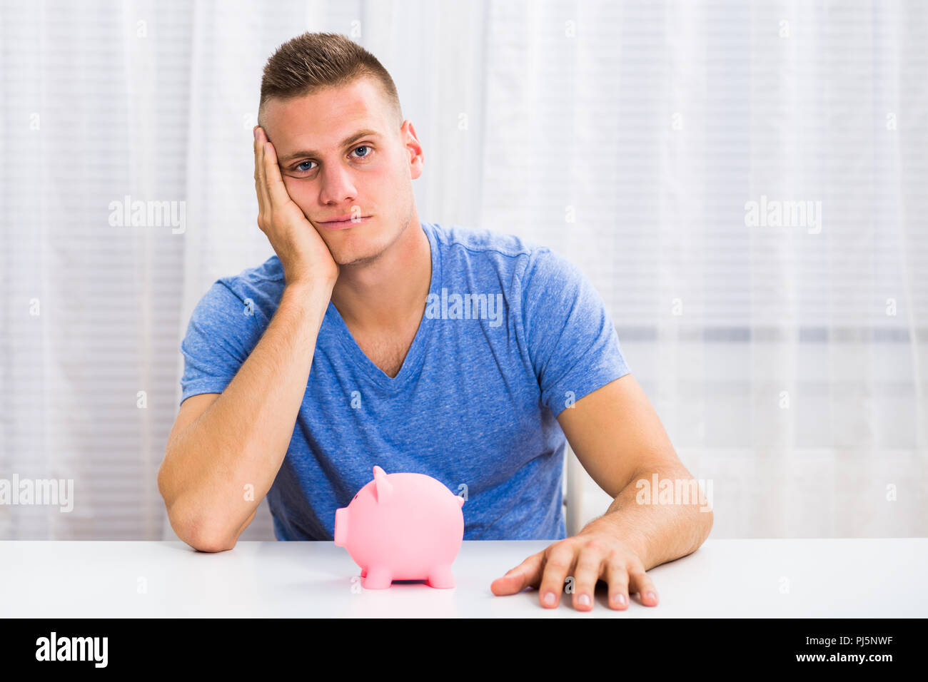 Young man is sad because he is having problem with saving money Stock ...