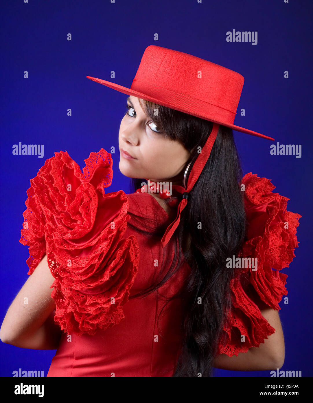 Young Spanish flamenco dancer posing in a red dress and hat Stock Photo ...