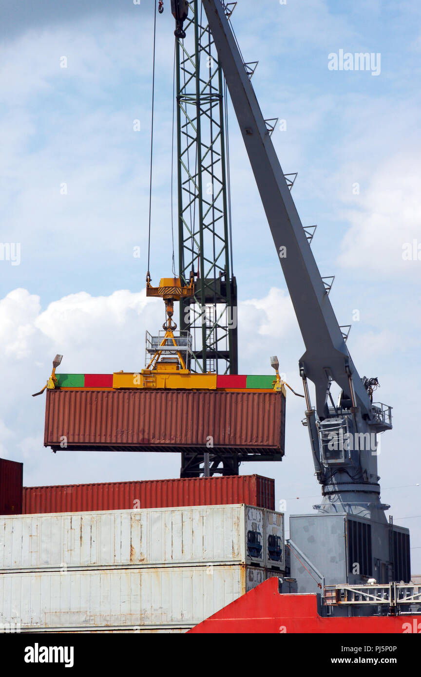 Detail of a large crane carrying one container into a ship (all brand ...