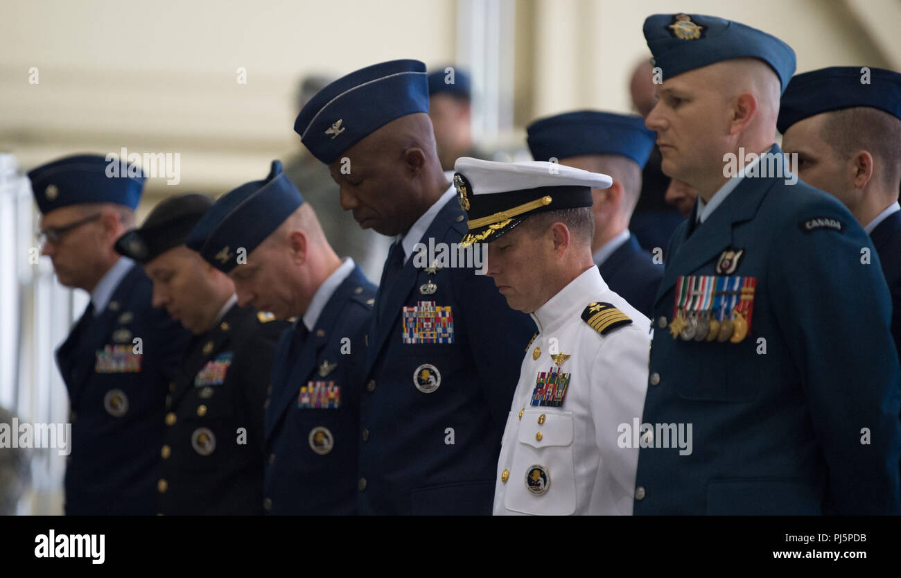Joint service members bow their heads during the invocation at a change ...
