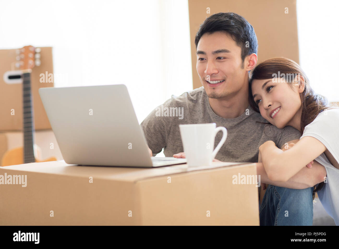 Couple laptop around cardboard hi-res stock photography and images - Alamy