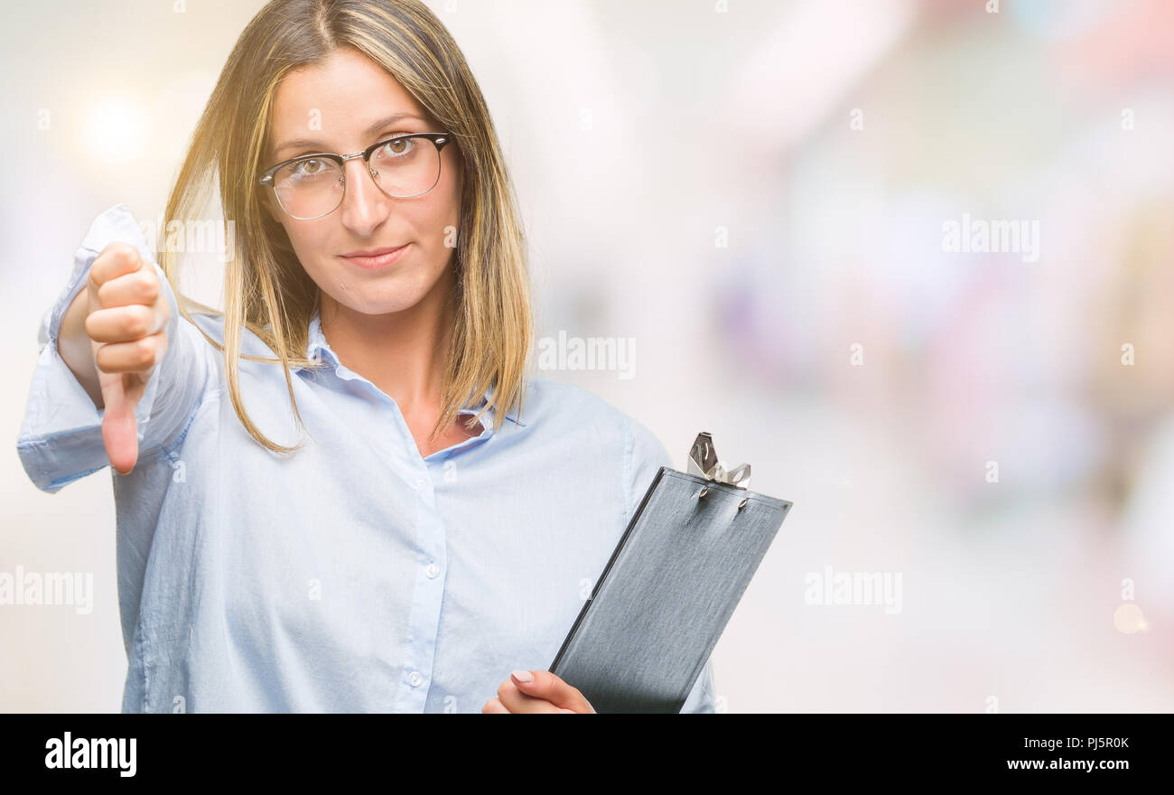 Young beautiful inspector business woman over isolated background with ...