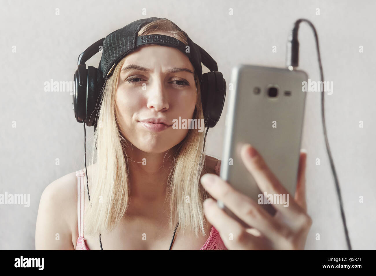 Happy girl listens and enjoys good music radio in headphones on white ...