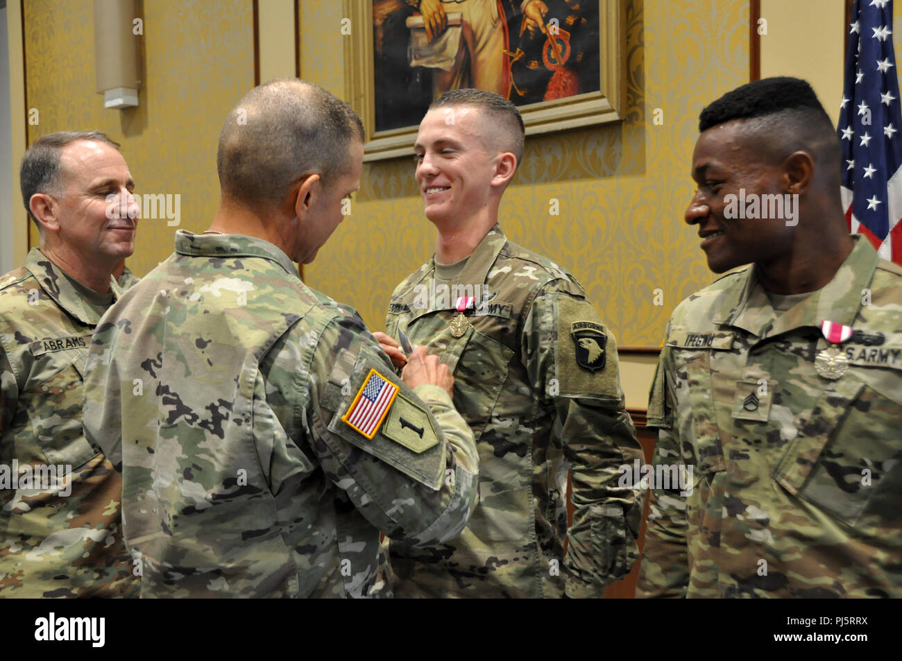 Pfc. Caden J. Emmons, center, is promoted to specialist by Command Sgt ...