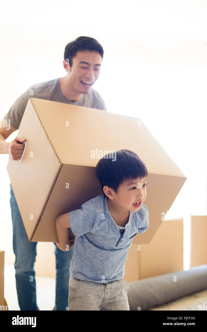 Happy young father and son moving home Stock Photo - Alamy