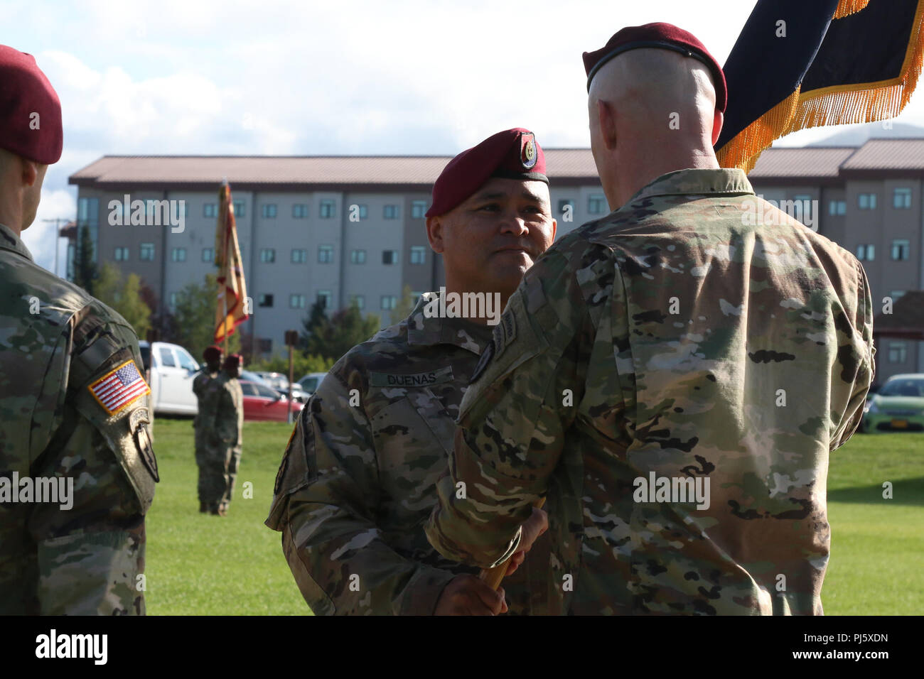 Command Sgt. Maj. Robert Duenas passes the unit colors to the brigade ...