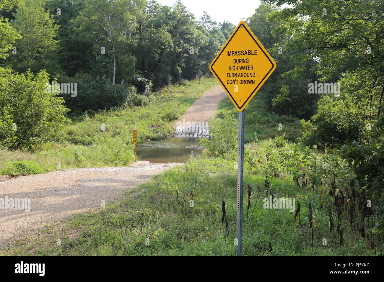 A sign indicating a warning for a water crossing is shown Aug. 28, 2018 ...