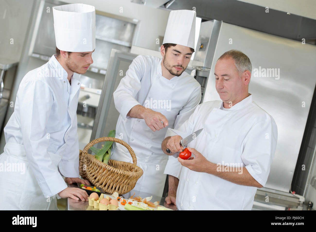 cooks working in a restaurant kitchen Stock Photo - Alamy