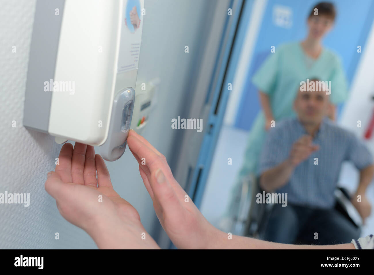 soap dispenser with a hand pushing on it Stock Photo - Alamy