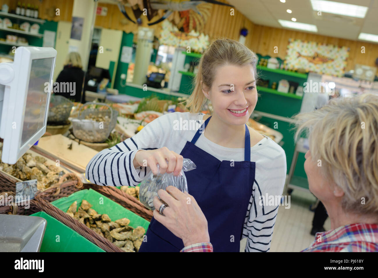 Girl selling fish hi-res stock photography and images - Alamy