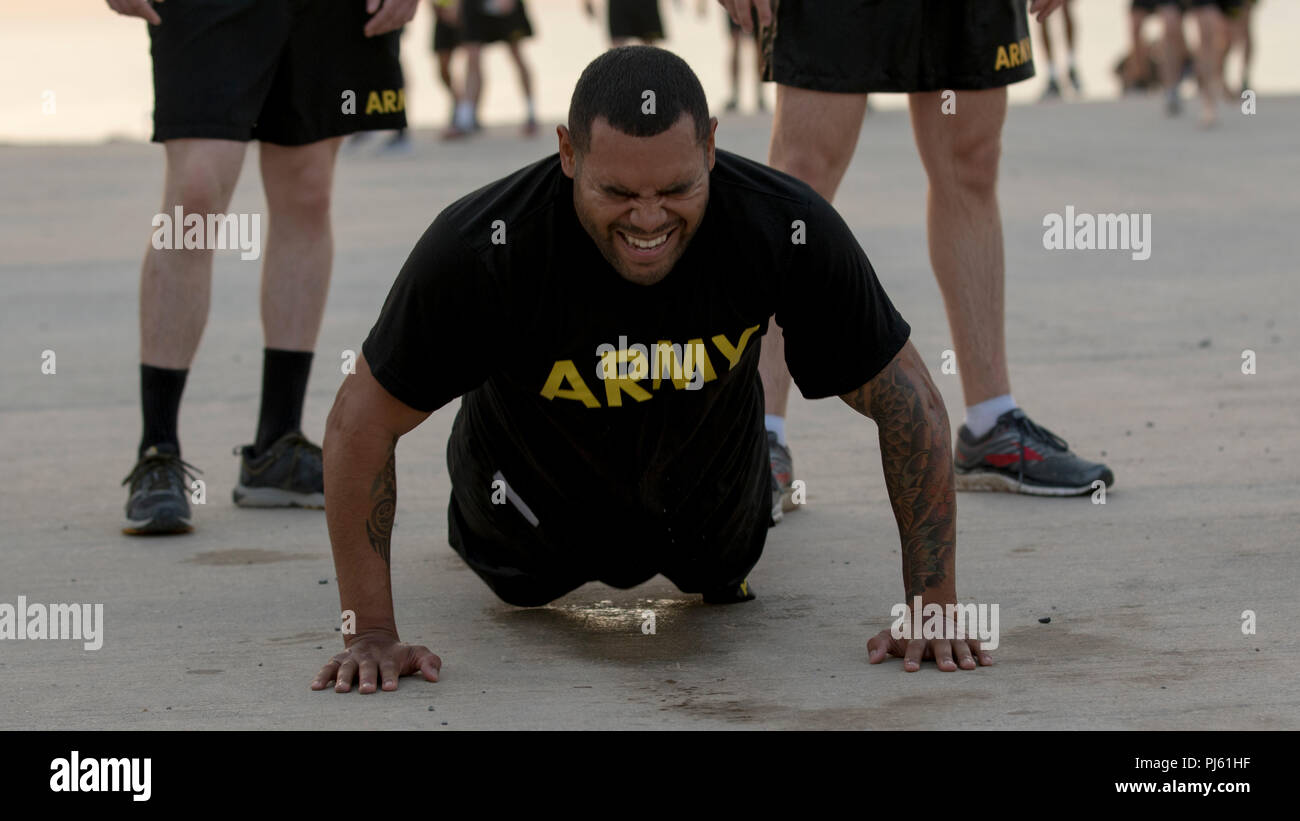 A U.S. Army Soldier grimaces as he raises himself up during the hand ...