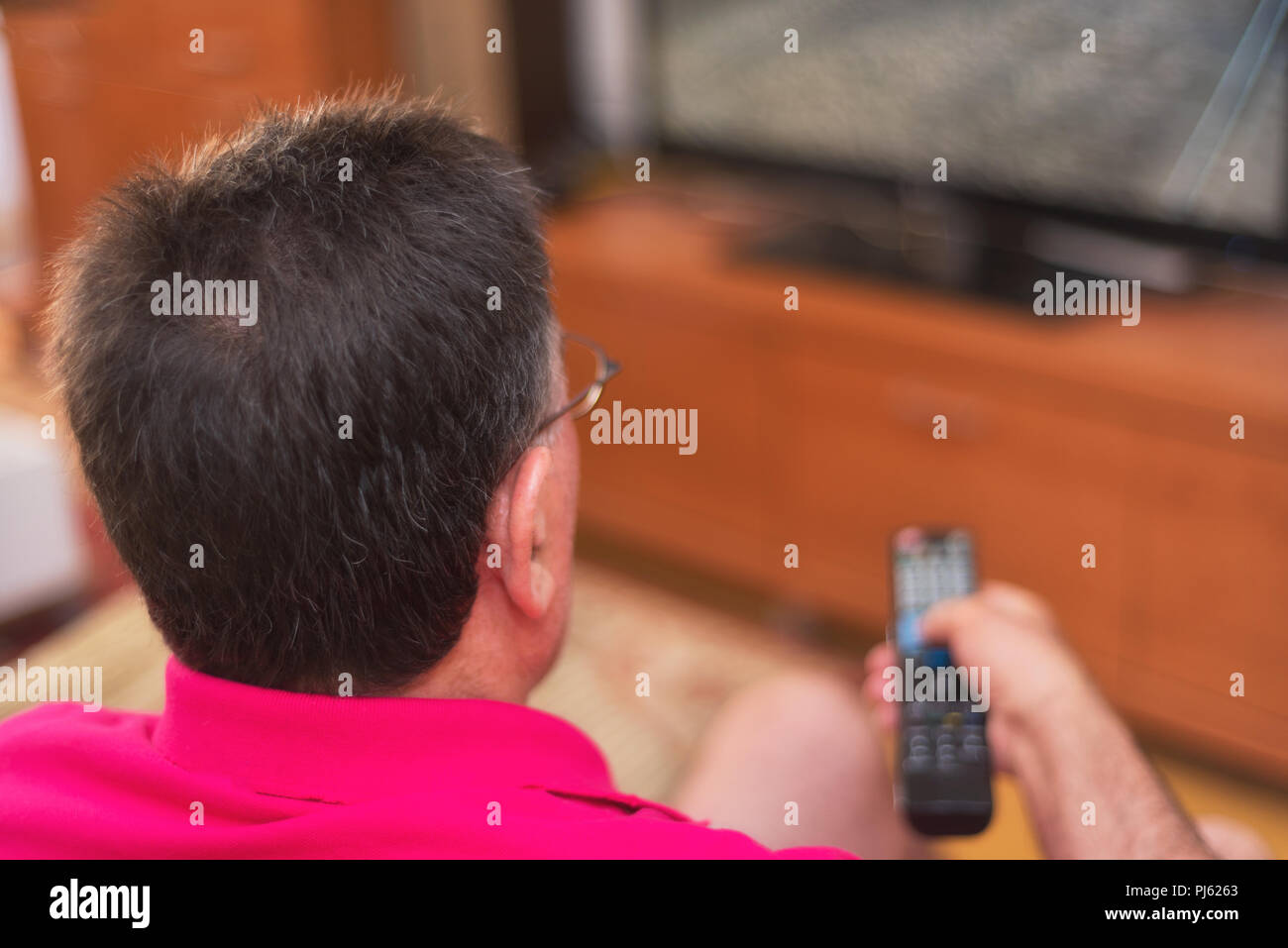 Senior man watching television hi-res stock photography and images - Alamy