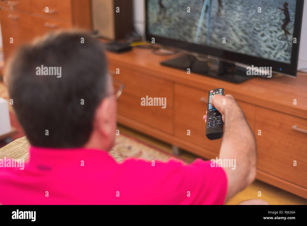Senior man watching television hi-res stock photography and images - Alamy