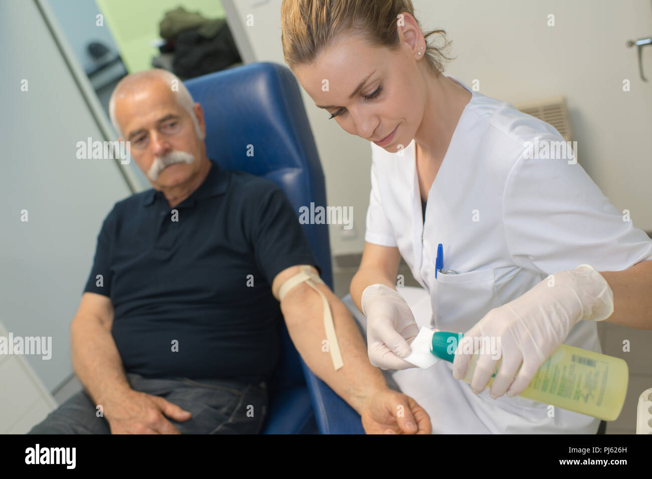 doctor testing blood to a senior patient Stock Photo - Alamy