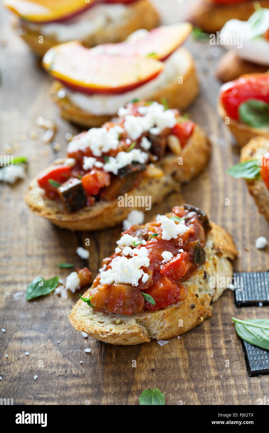 Crostini or bruschetta board with eggplant caponata and feta Stock ...