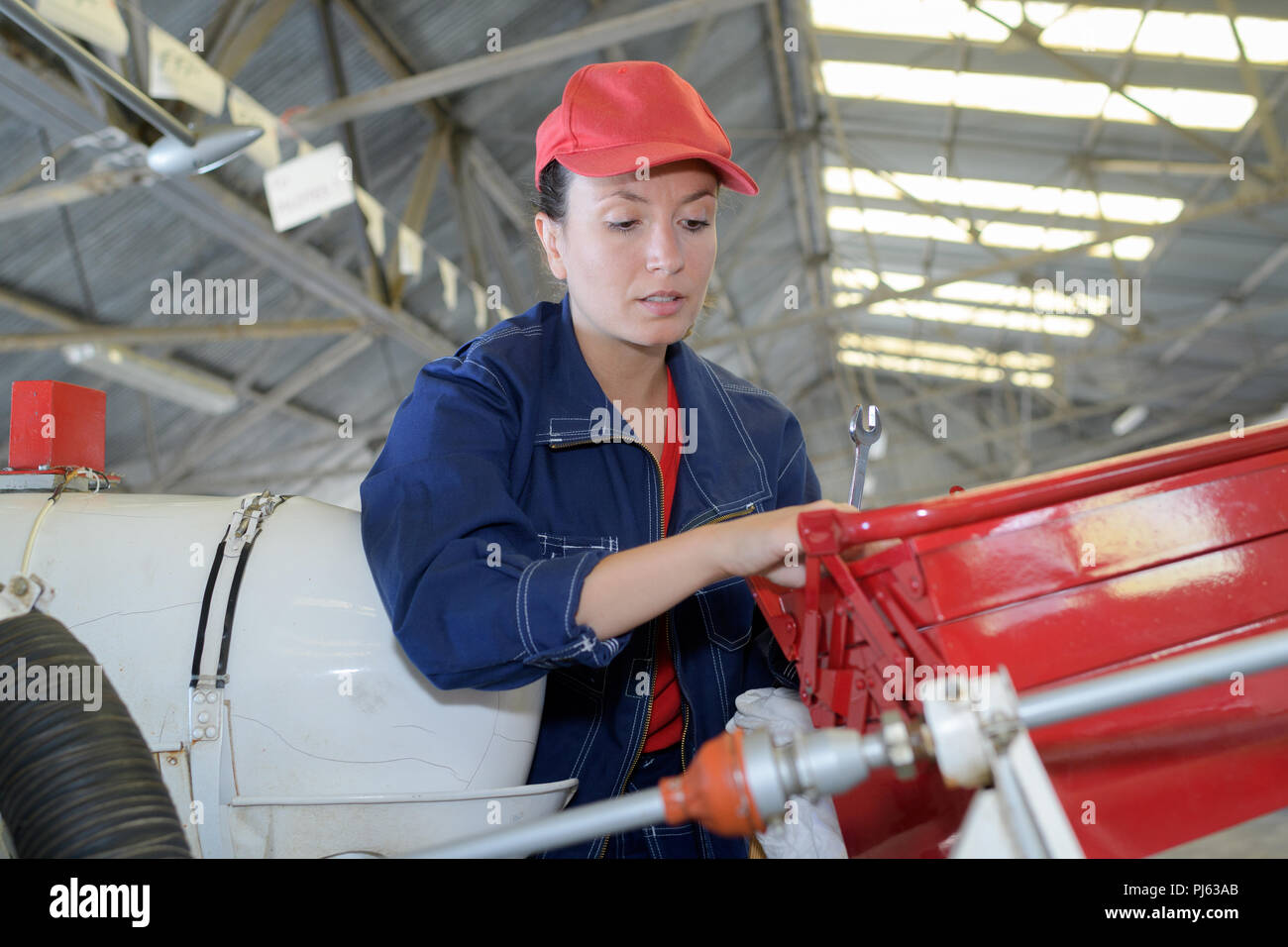 female helicopter mechanic working hard Stock Photo - Alamy