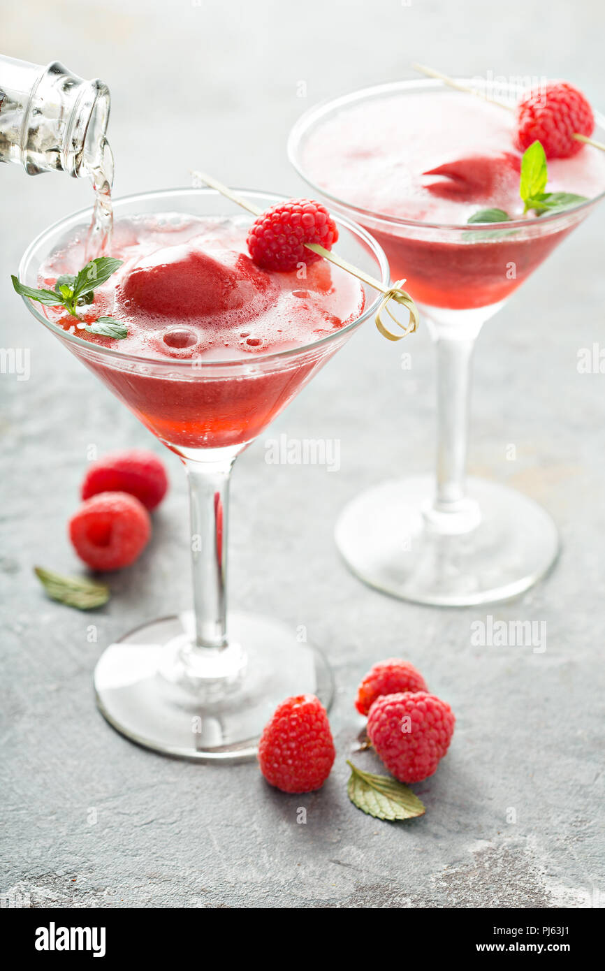 Sparkling rose and raspberry sorbet floats with fresh berries Stock ...