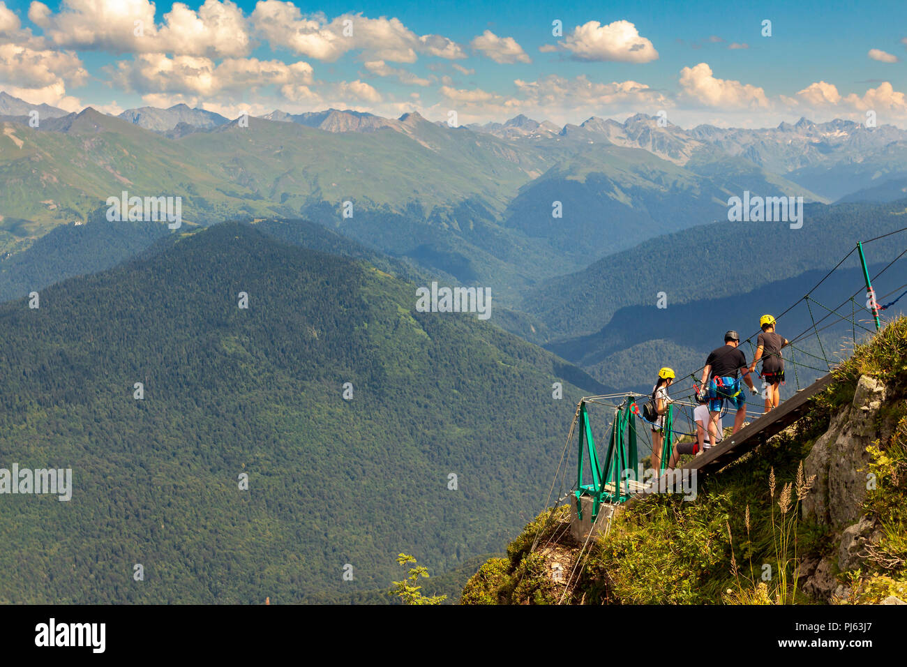 Young woman crossing the chasm on the rope bridge, Sochi, Russia Stock ...