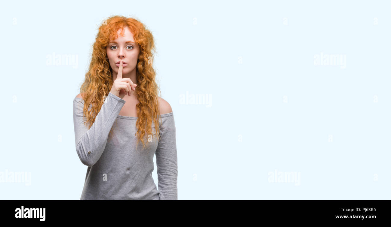 Young Redhead Woman Asking To Be Quiet With Finger On Lips Silence And
