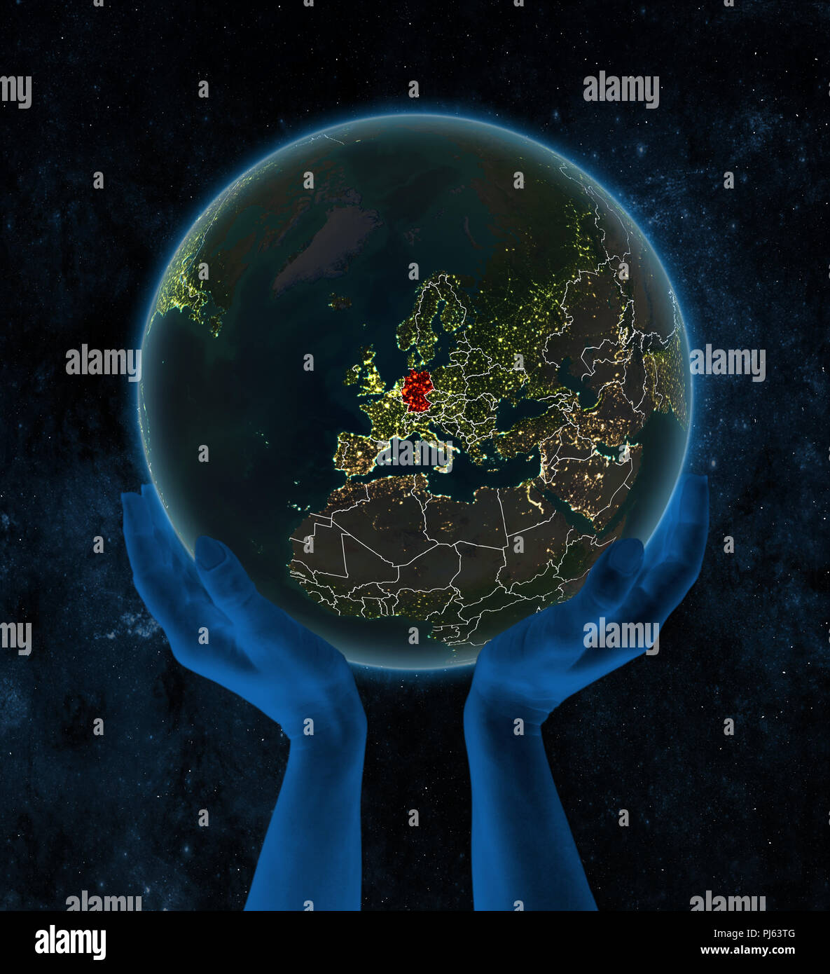 Germany on night planet Earth with visible country borders in hands in ...