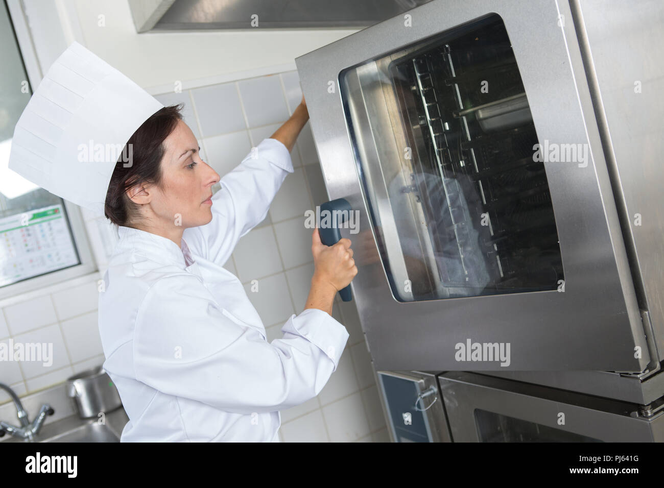 chef opening an oven Stock Photo - Alamy