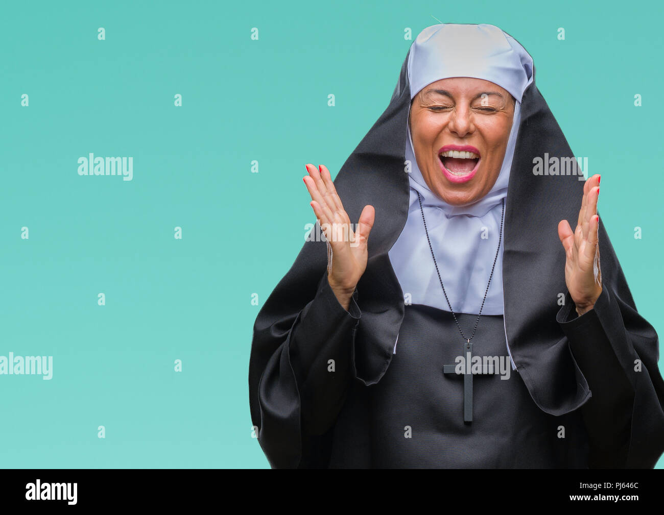 Middle age senior christian catholic nun woman over isolated background ...
