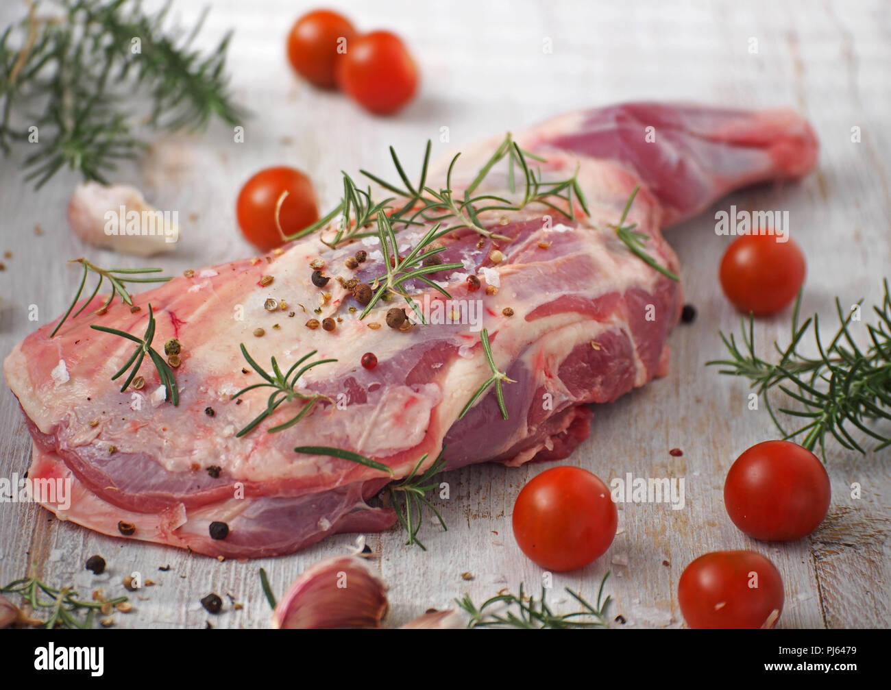 Fresh and raw meat. Leg of lamb on wood background Stock Photo - Alamy