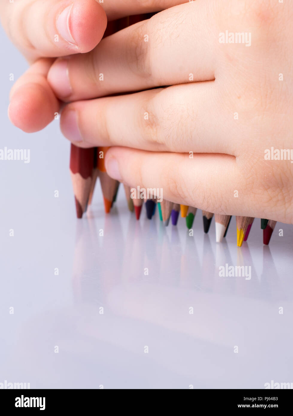 Hand holding color Pencils placed on a white background Stock Photo - Alamy