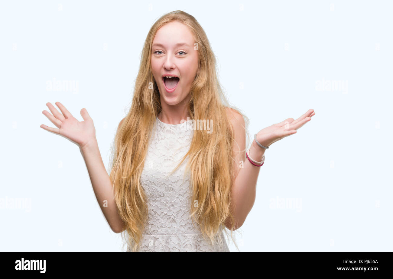 Blonde teenager woman very happy and excited, winner expression ...